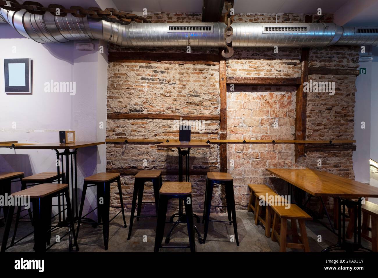 High wooden tables and dining table with matching wooden stools Stock ...