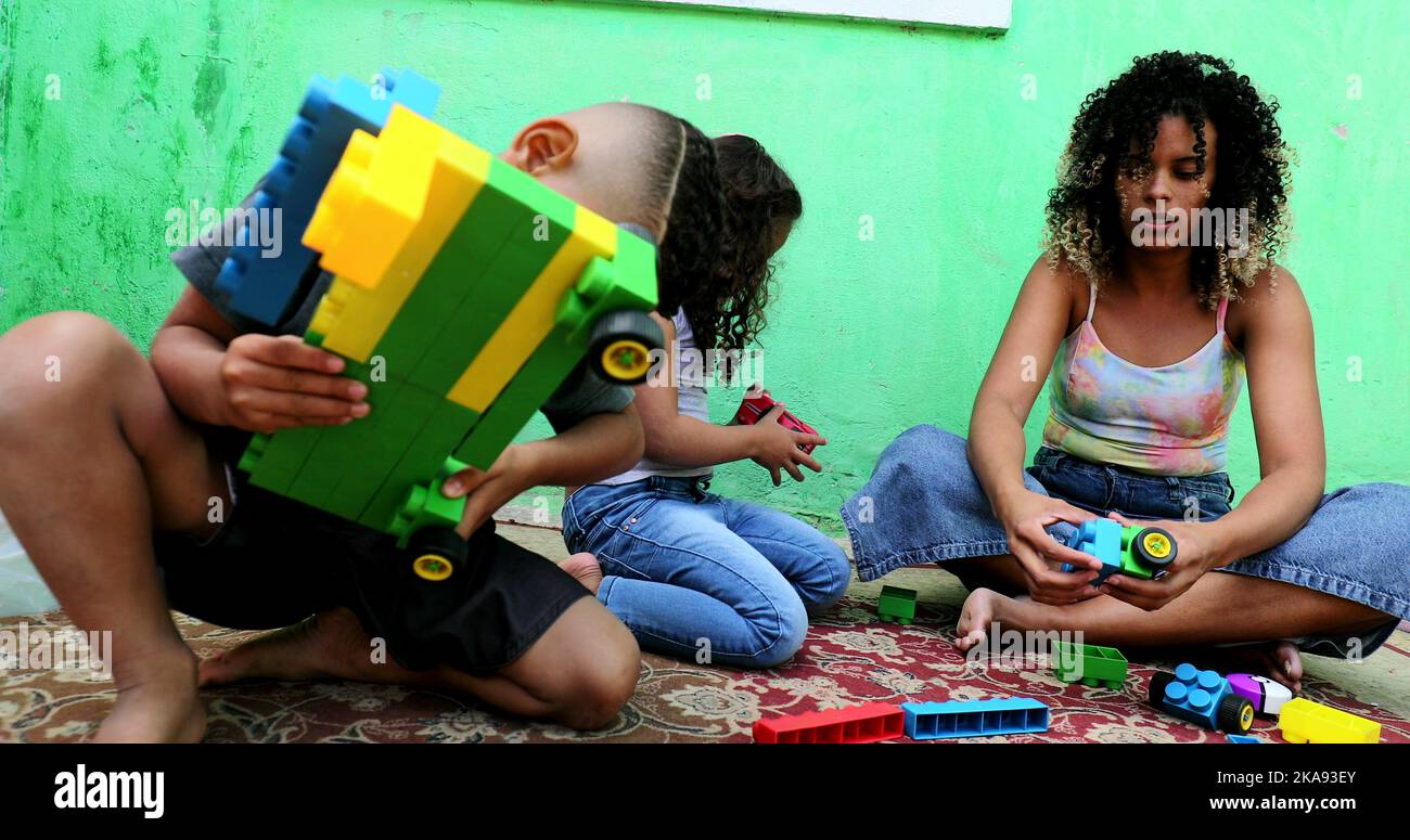 Hispanic children playing home with toys Stock Photo - Alamy