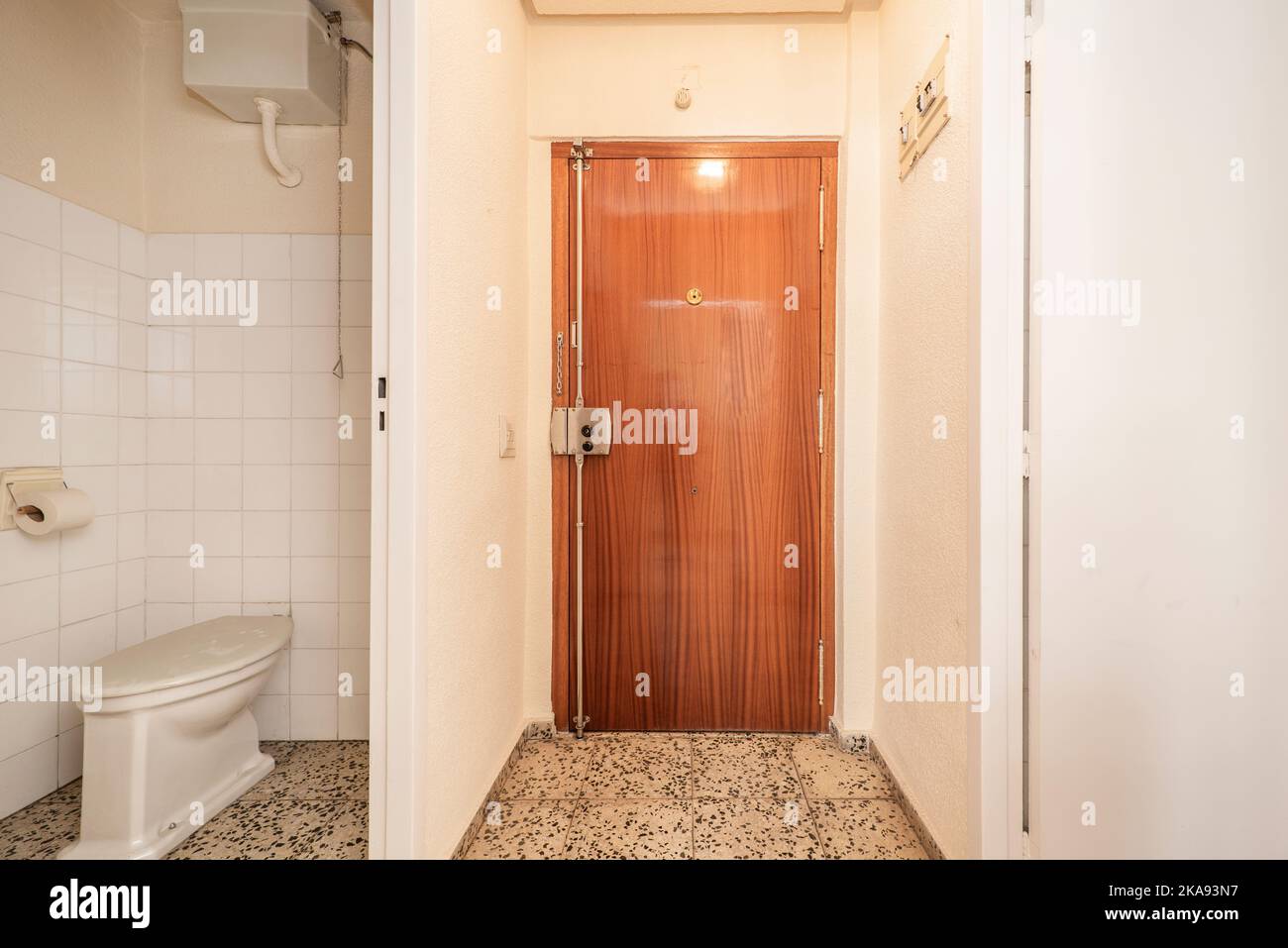 Service hall of an old house with a small toilet and terrazzo floors ...