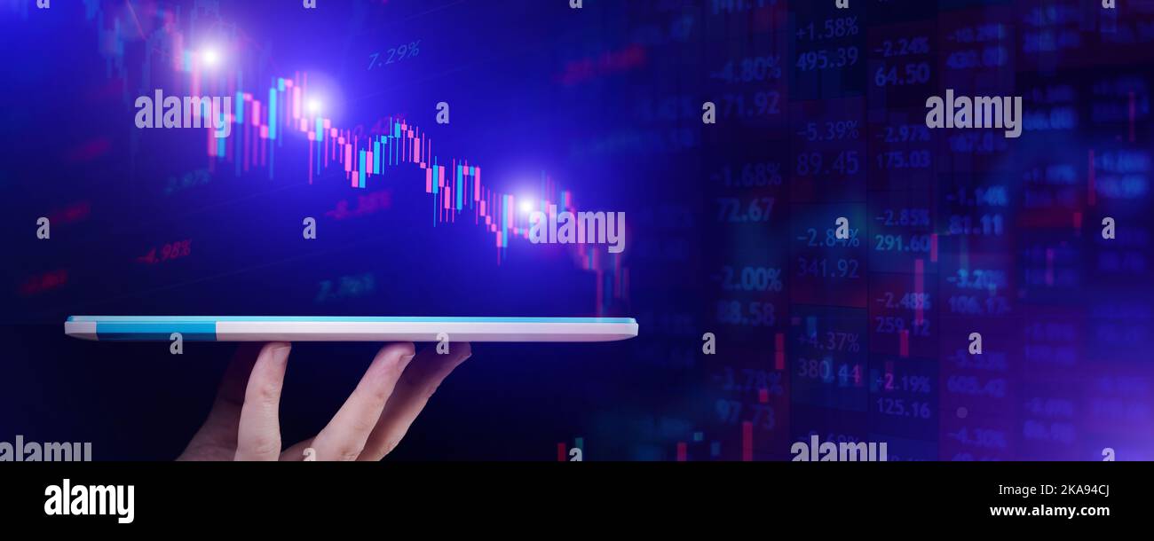 Falling stock chart emerges from a tablet that a man holds Stock Photo ...
