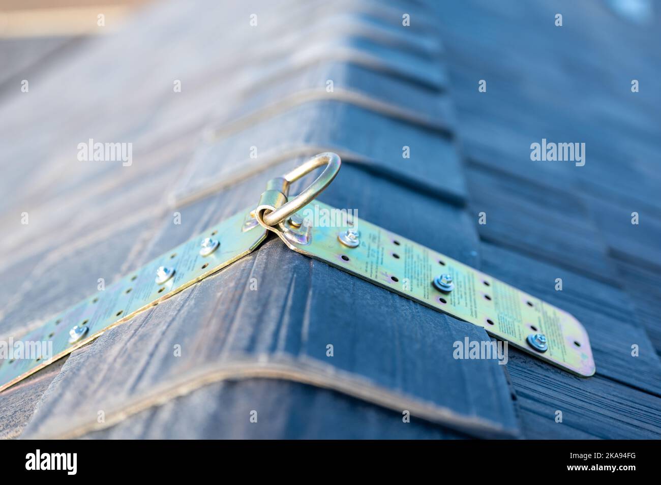 Selective focus on a metal temporary anchor installed on the peak of a ...