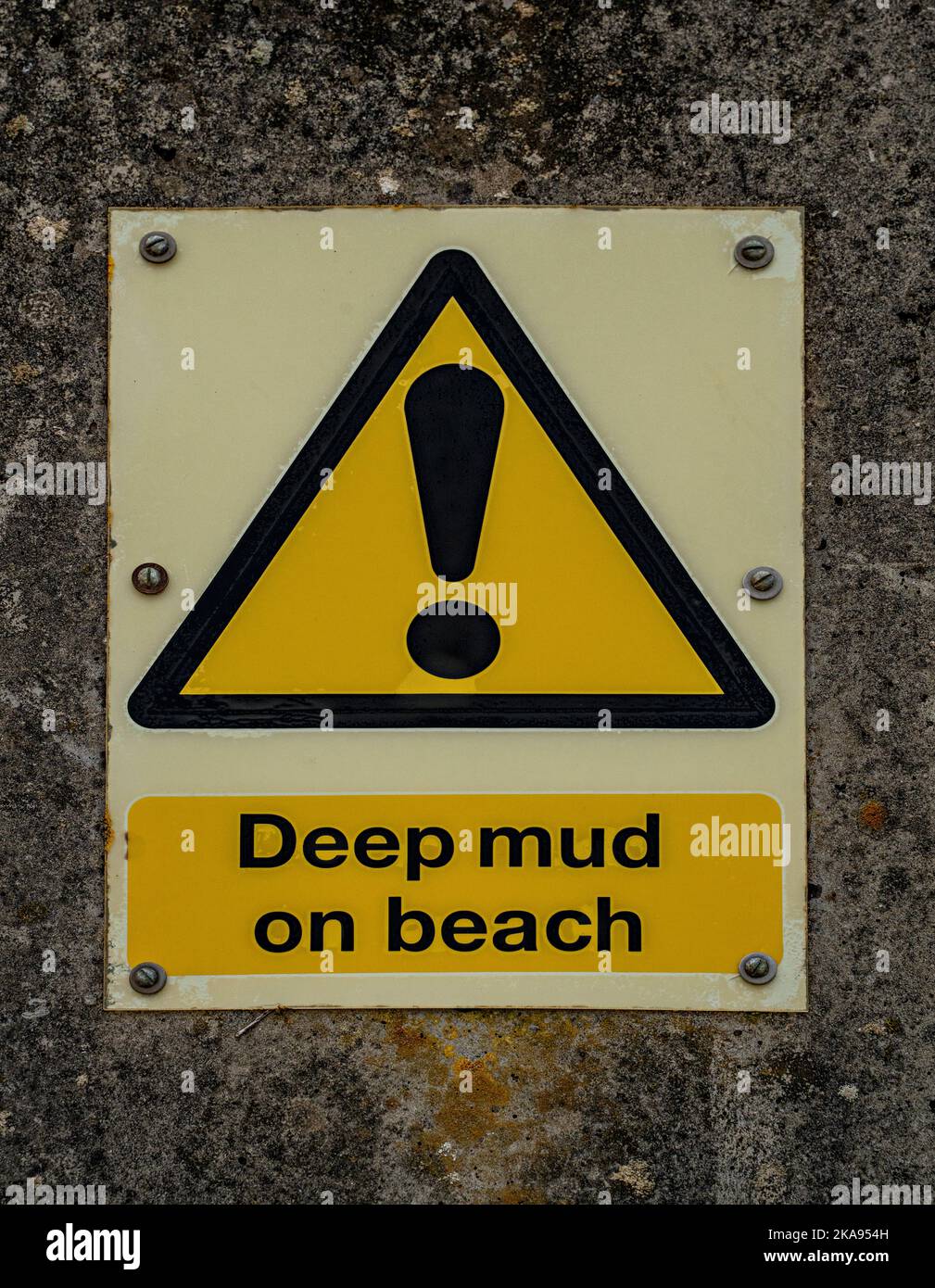 Warning triangular sign: Deep Mud on Beach Stock Photo - Alamy