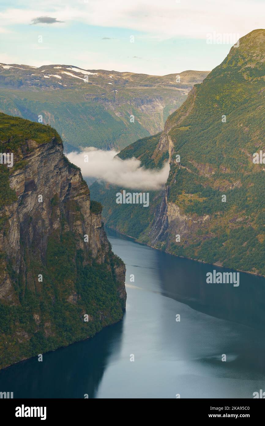 An aerial view of a fjord surrounded by cliffs in Geiranger, Norway ...