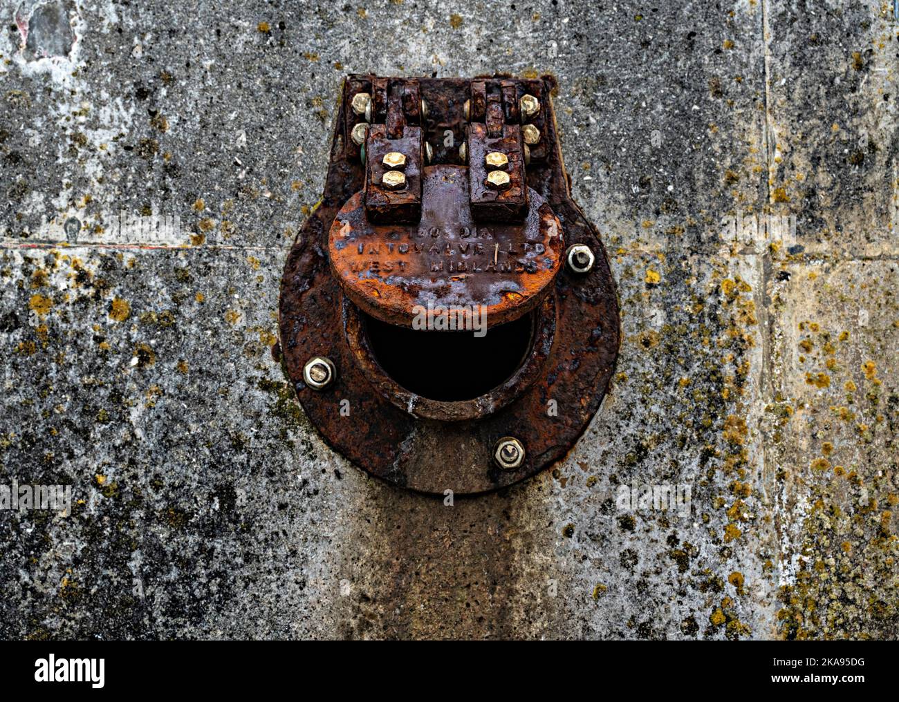 Iron valve set in concrete sea wall, Morecambe, Lancashire Stock Photo ...