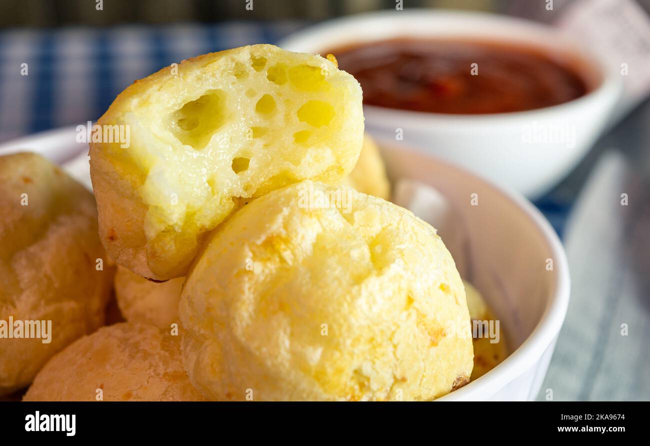 A soft focus of a bowl of round Brazilian cheese bread on a breakfast ...