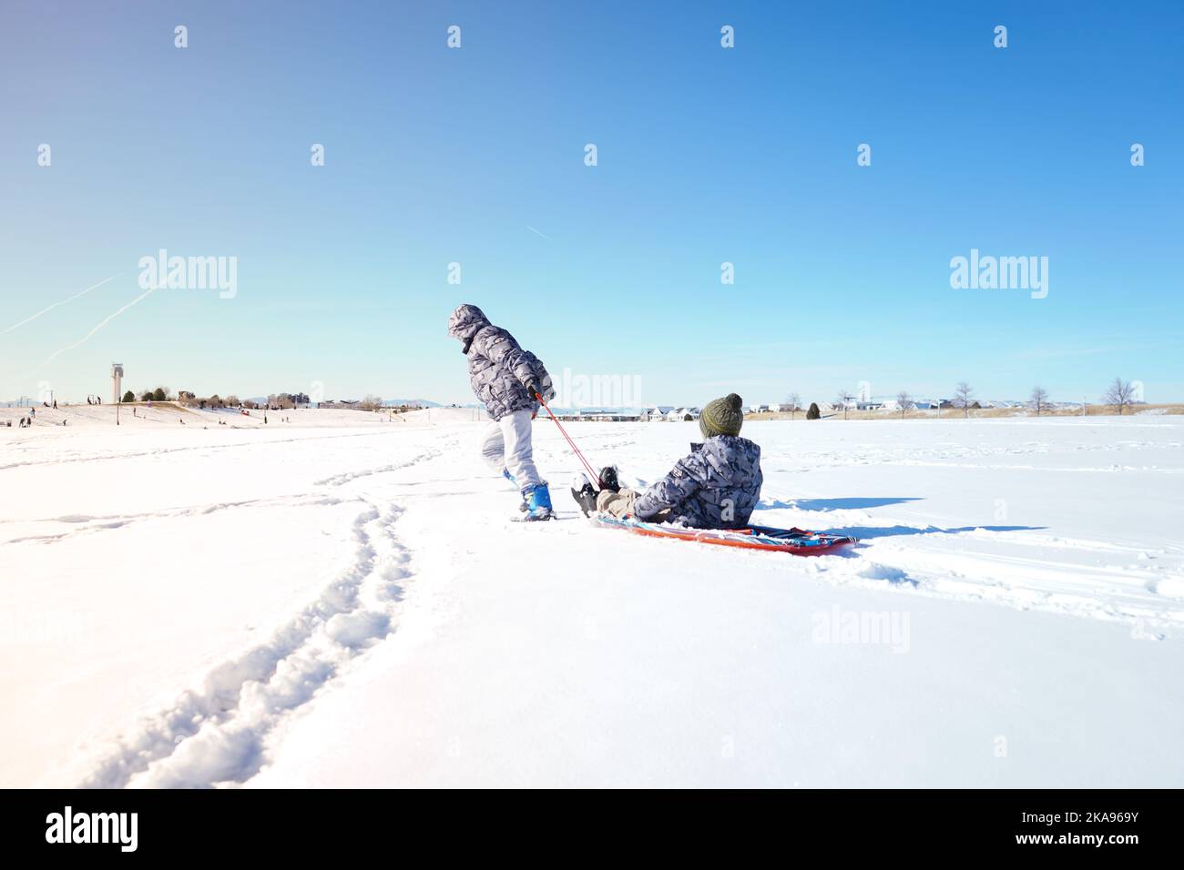 Children laughter have fun sledding on a sunny day on winter denver ...