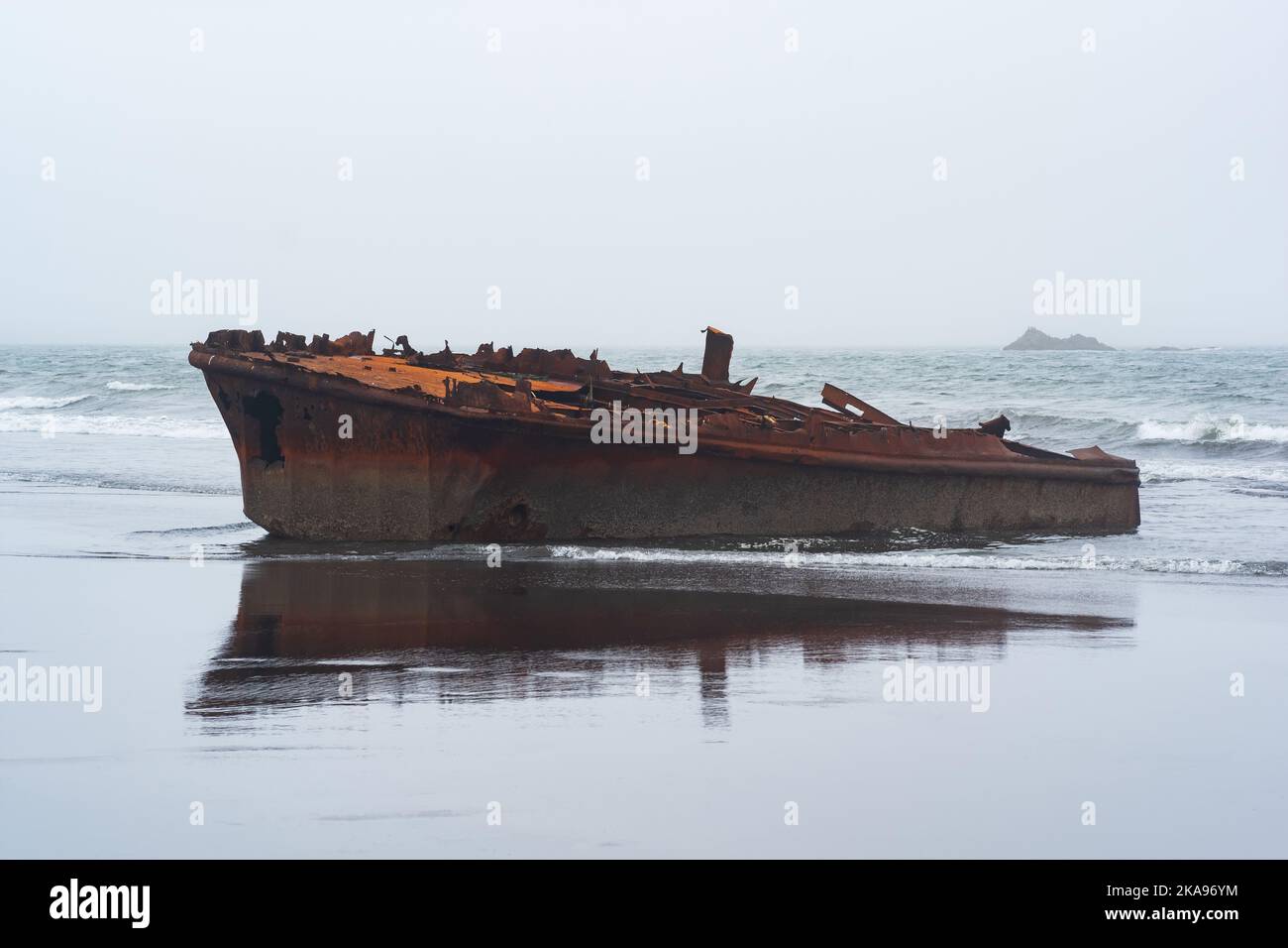 rusty shipwreck, remains of a ship washed ashore against a foggy ...