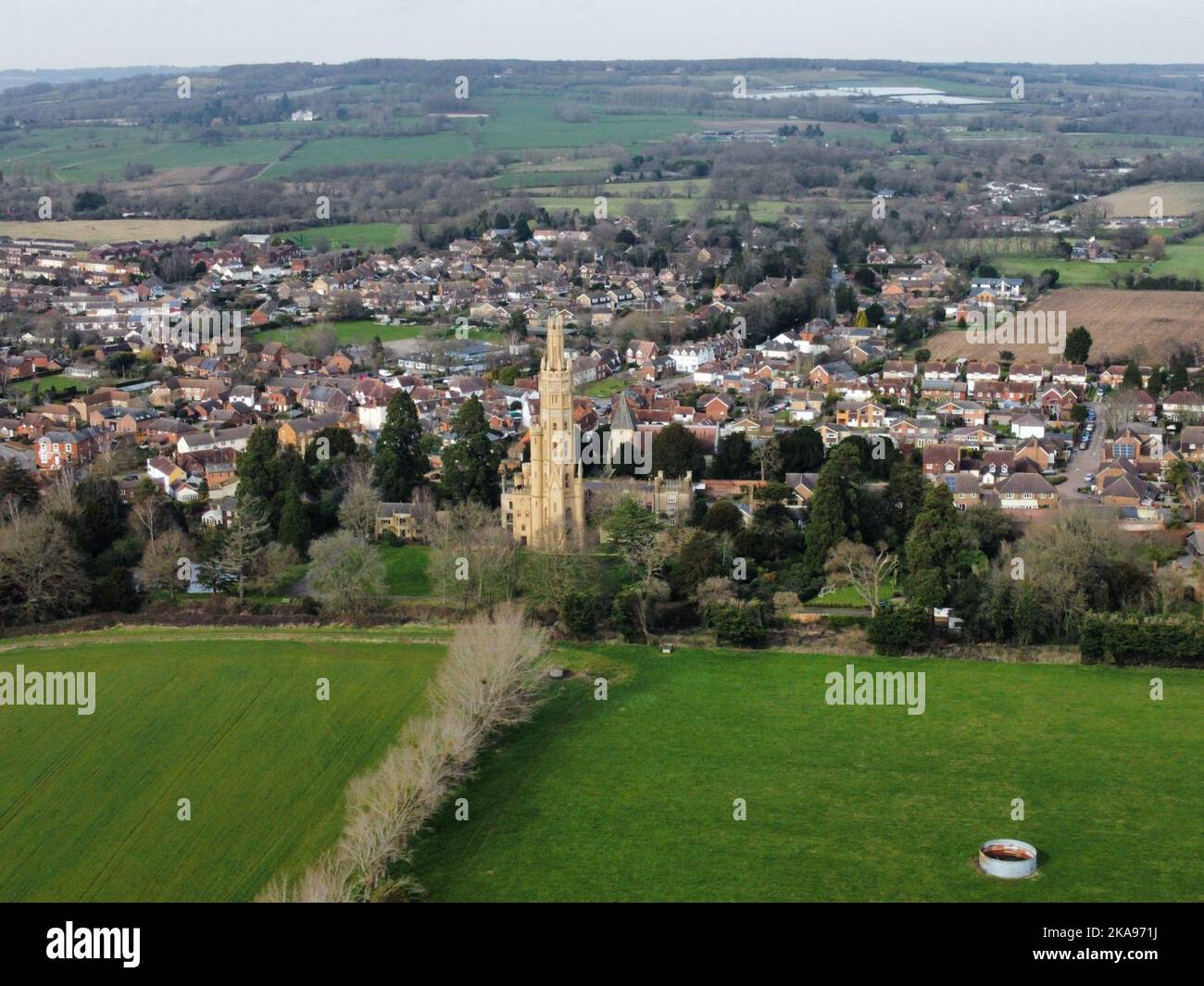 The view of the Hadlow Castle tower against the city buildings. Kent ...