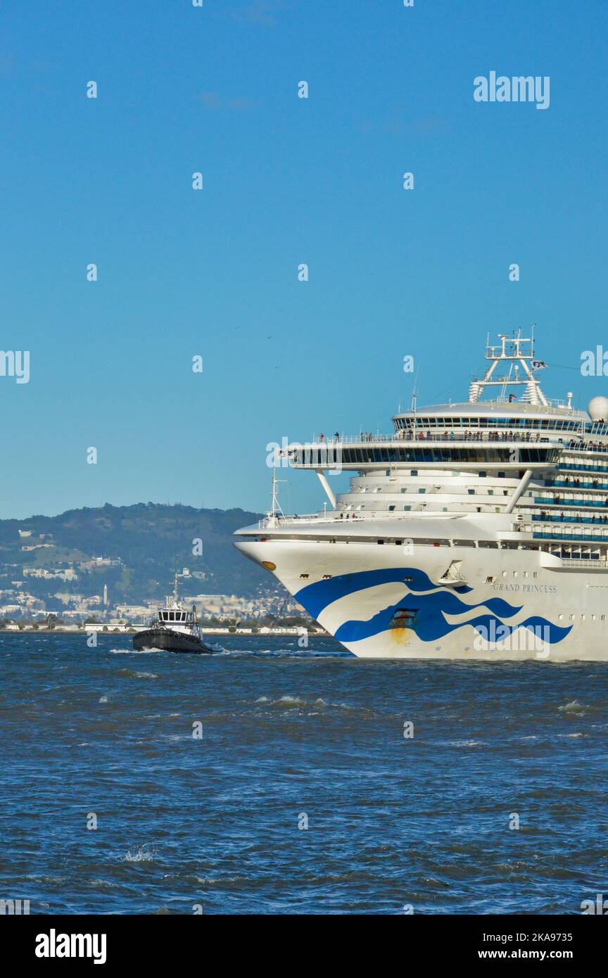 A vertical shot of a big ship named Princess near tow boat in the ocean ...