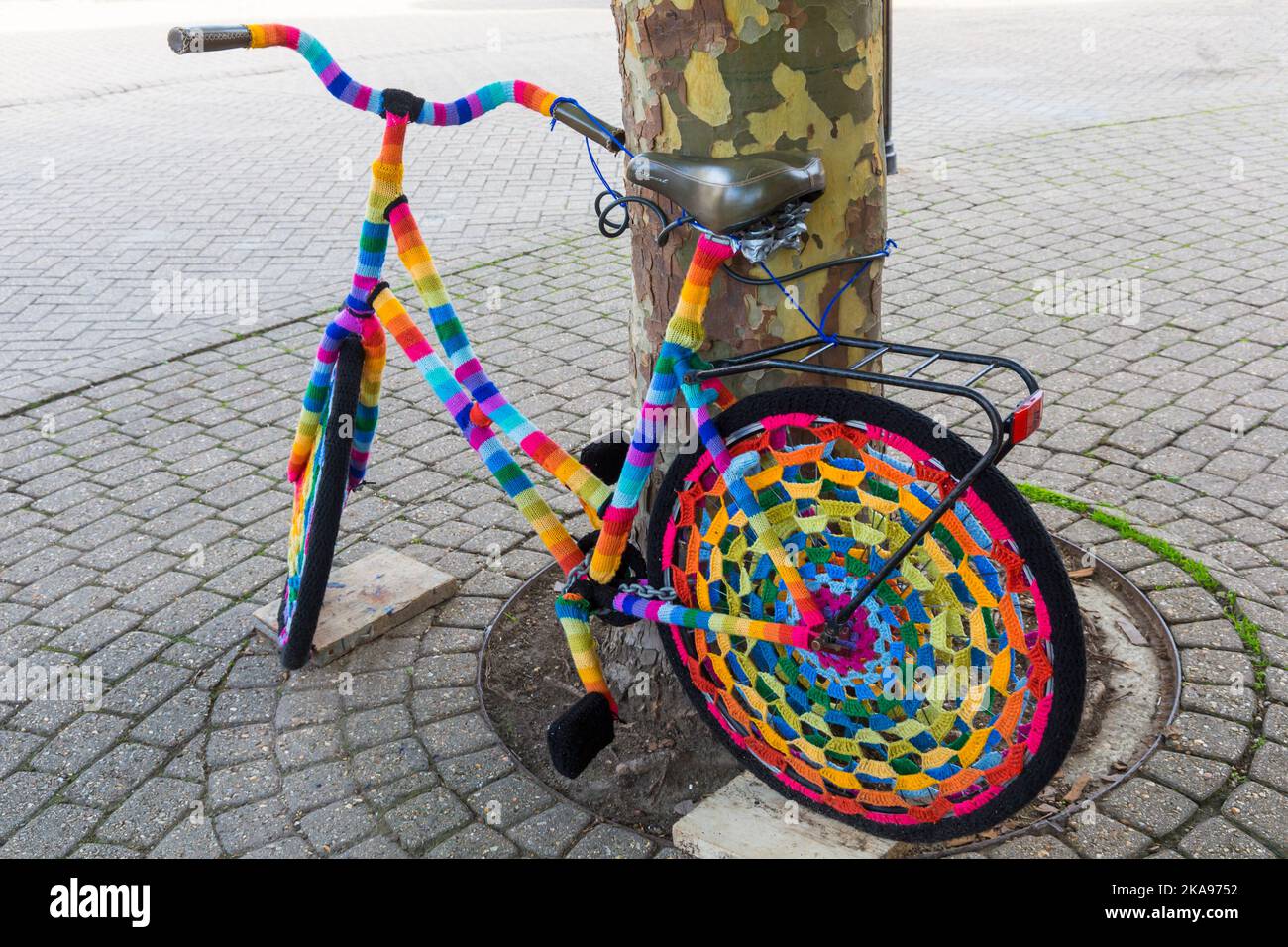 Colourful yarn bombing bike, yarn bomb crochet crocheted bike against ...