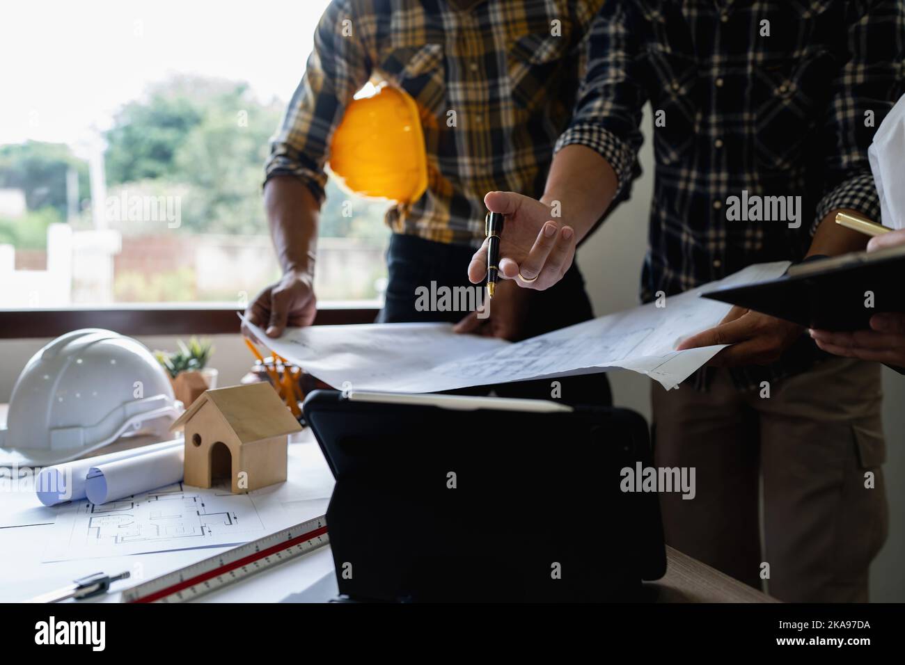 Architect man working with blueprints for architectural plan, engineer ...