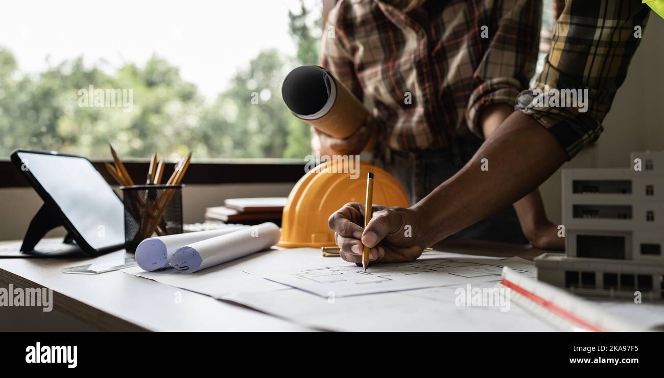 Architect man working with blueprints for architectural plan, engineer ...