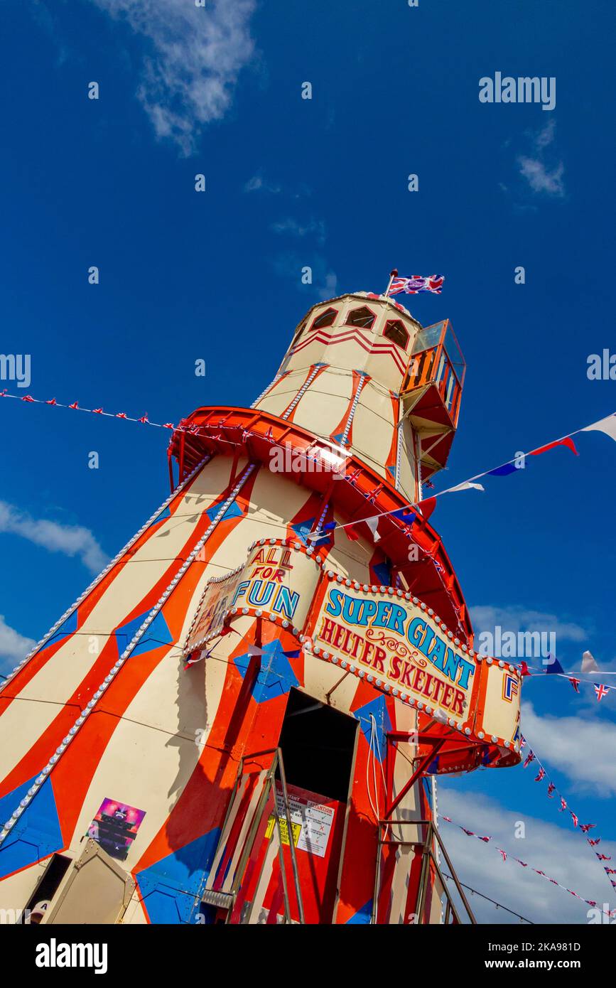 Helter skelter funfair rides at a fairground near Hunstanton beach in ...