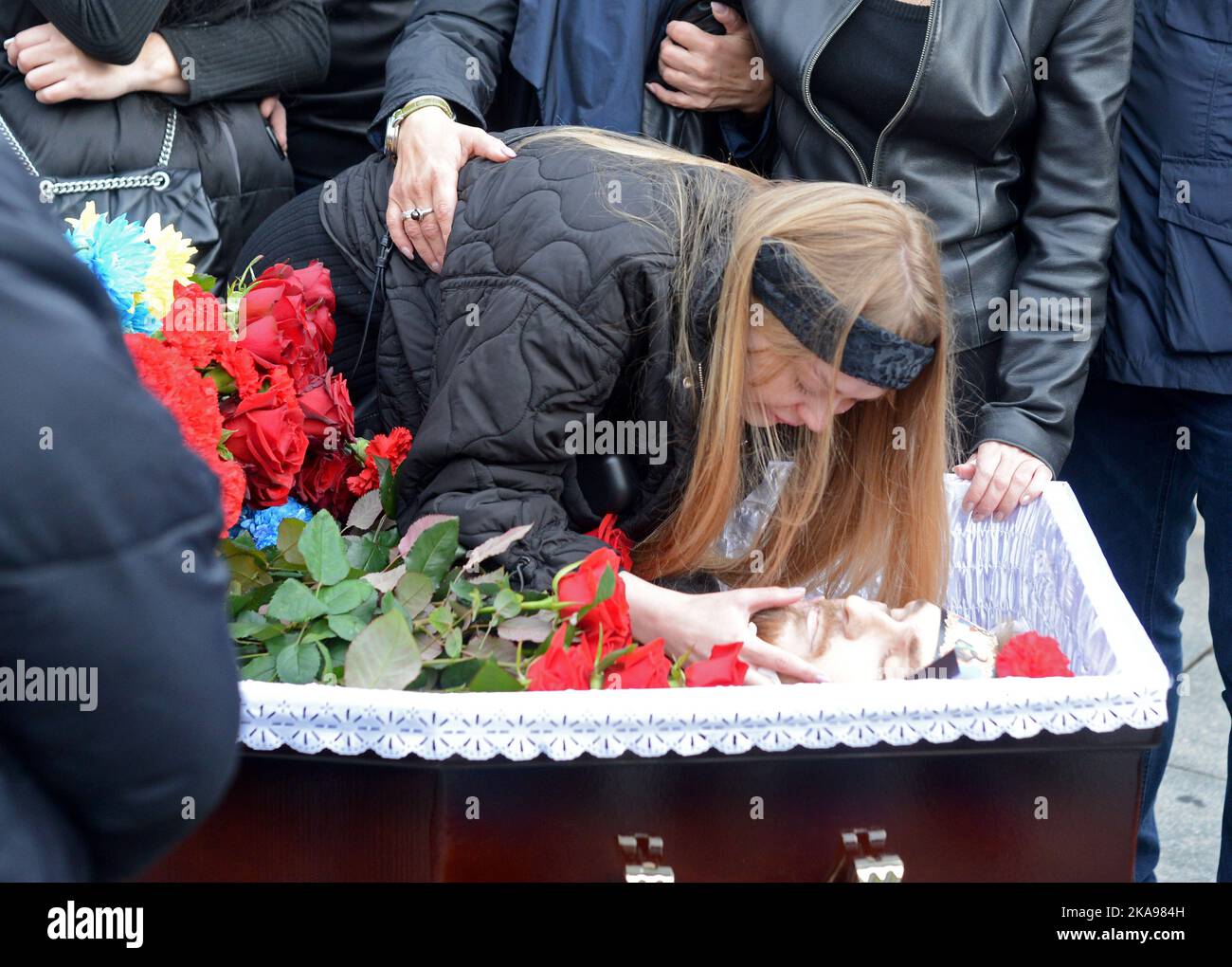 KYIV, UKRAINE - OCTOBER 29, 2022 - A woman cries over the coffin of ...