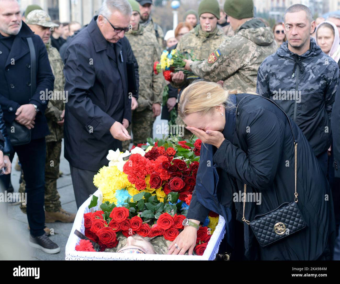 KYIV, UKRAINE - OCTOBER 29, 2022 - A woman cries over the coffin of ...