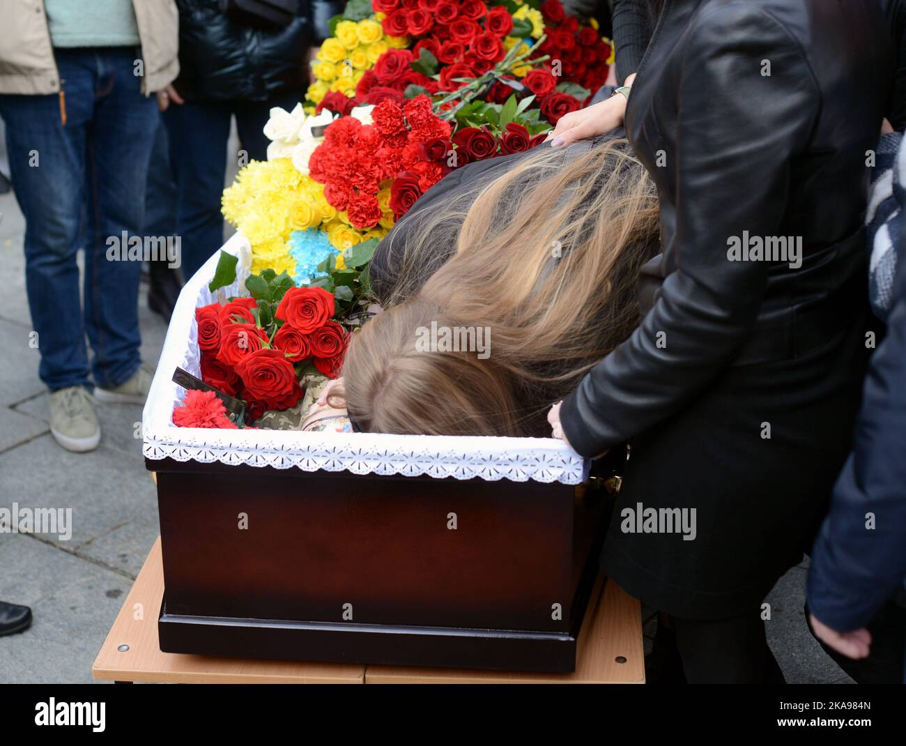 KYIV, UKRAINE - OCTOBER 29, 2022 - A woman cries over the coffin of ...