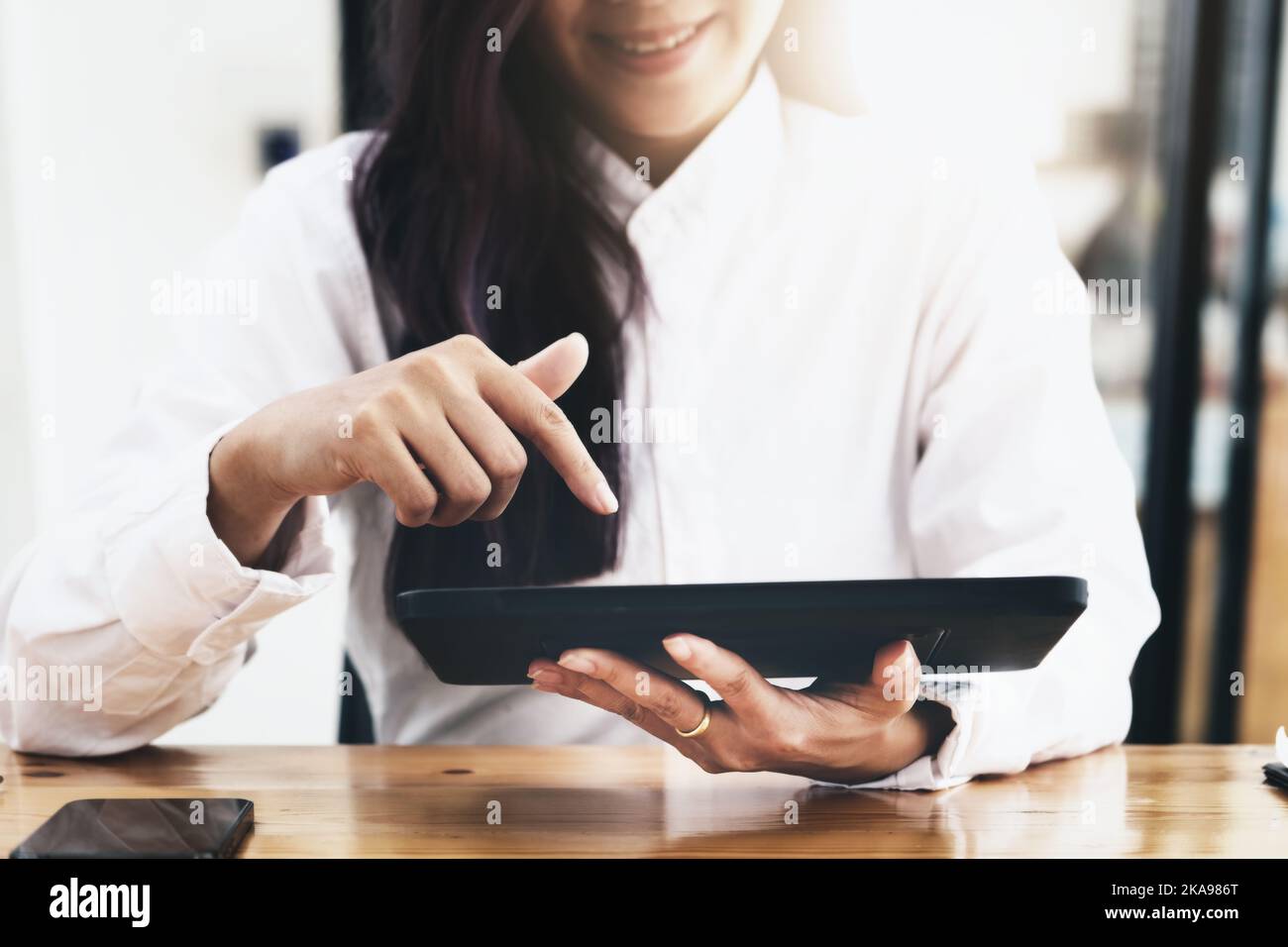 Woman using ipad for working in office room Stock Photo - Alamy