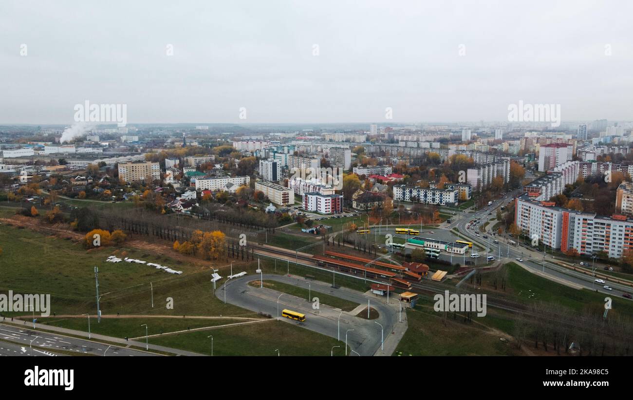 Railroad station. Platform and railroad tracks. Multi-storey buildings ...