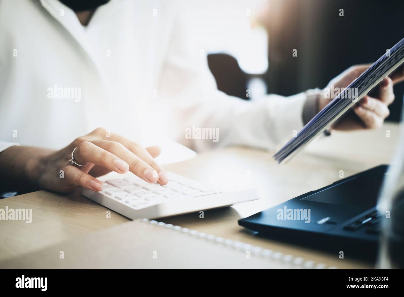 Business woman using calculator to review balance sheet annual using ...