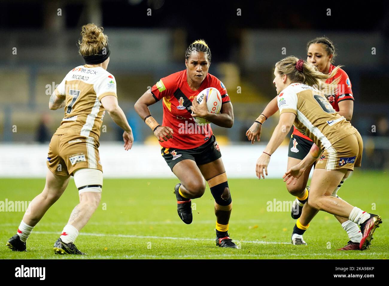 Papua New Guinea's Martha Molowia (centre) its tackled by Canada's ...