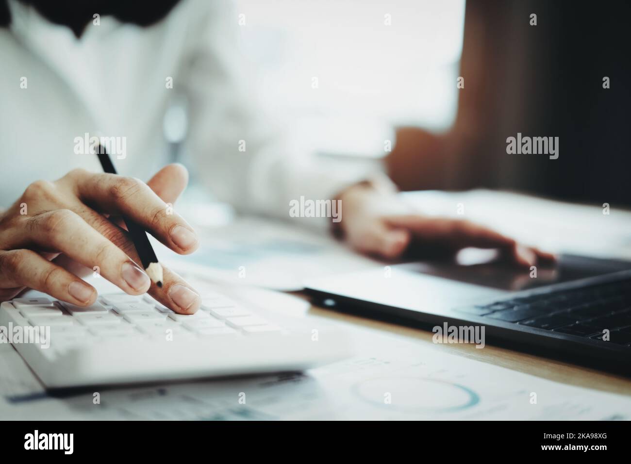 Business woman using calculator to review balance sheet annual using ...