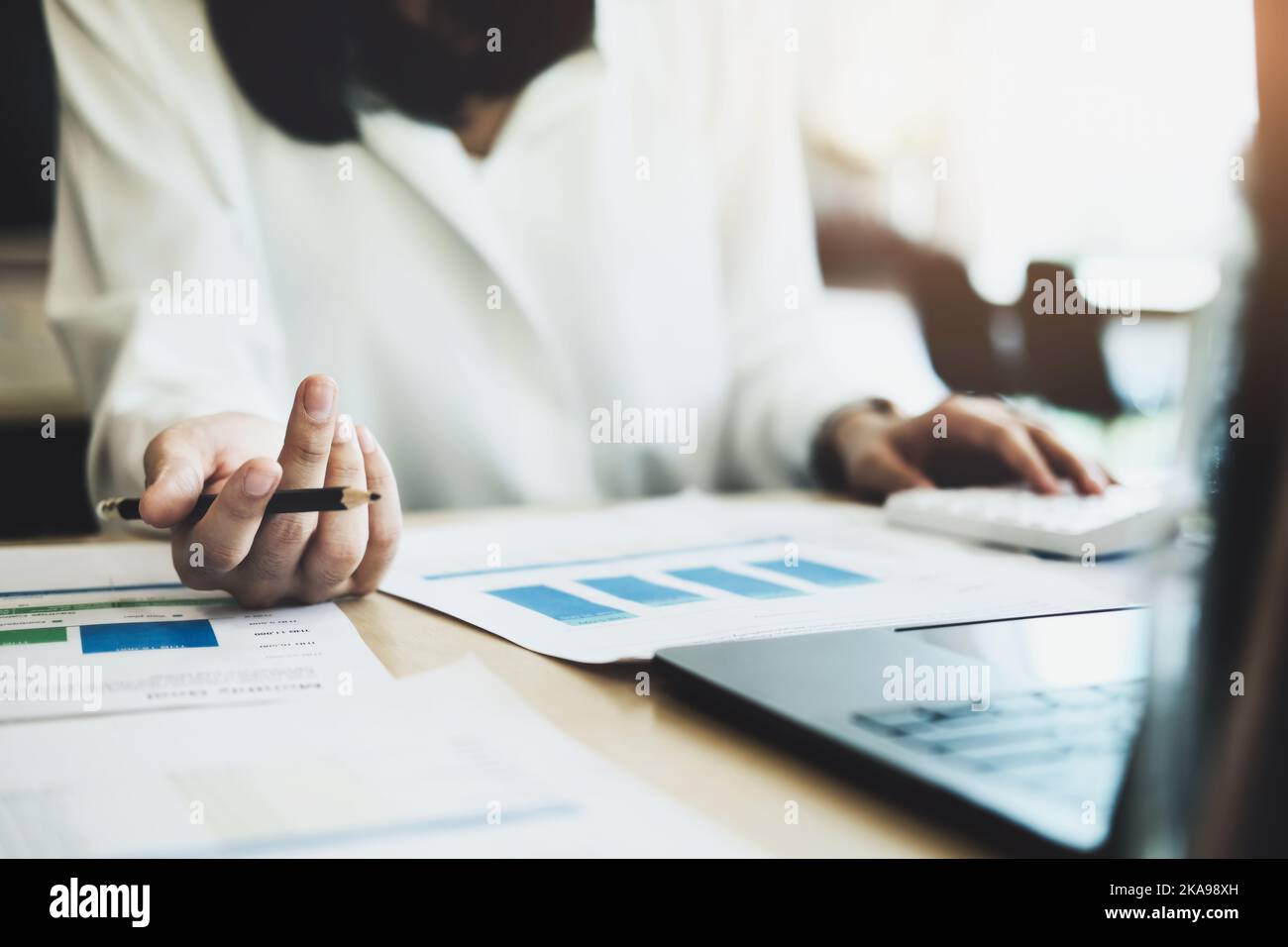 focus-woman-holding-a-pencil-auditors-use-budget-document-calculators