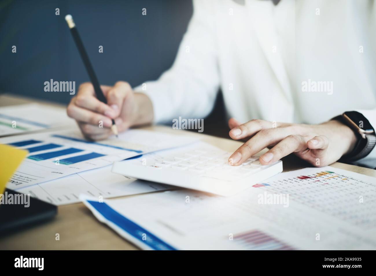 Business woman using calculator to review balance sheet annual using ...