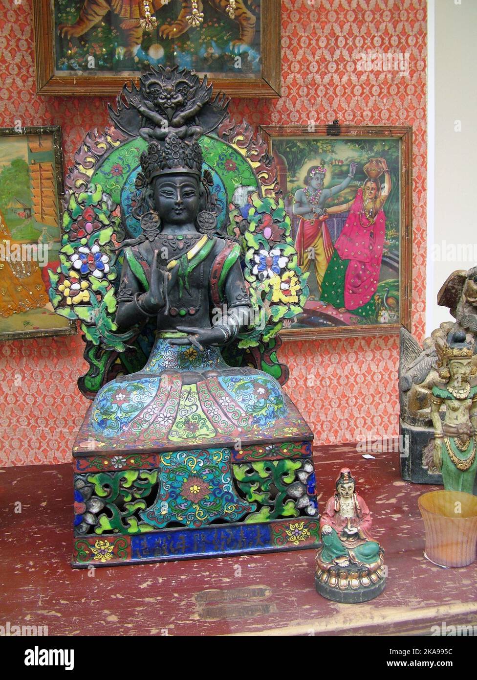 A vertical closeup of a colorful statue of a Buddha Stock Photo - Alamy