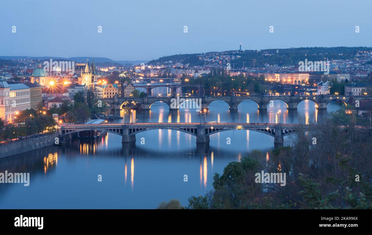 Evening blue hour panorama of city with Vltava river and its bridges ...