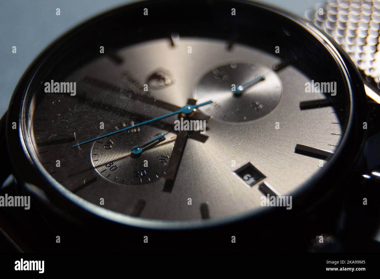 A closeup of a black wristwatch under a light Stock Photo - Alamy