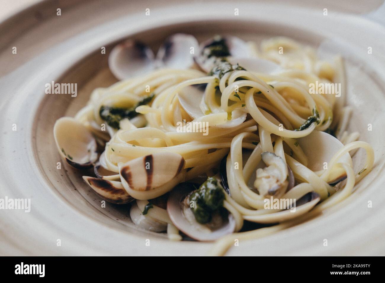 A closeup shot of spaghetti with arselle in a white plate Stock Photo ...