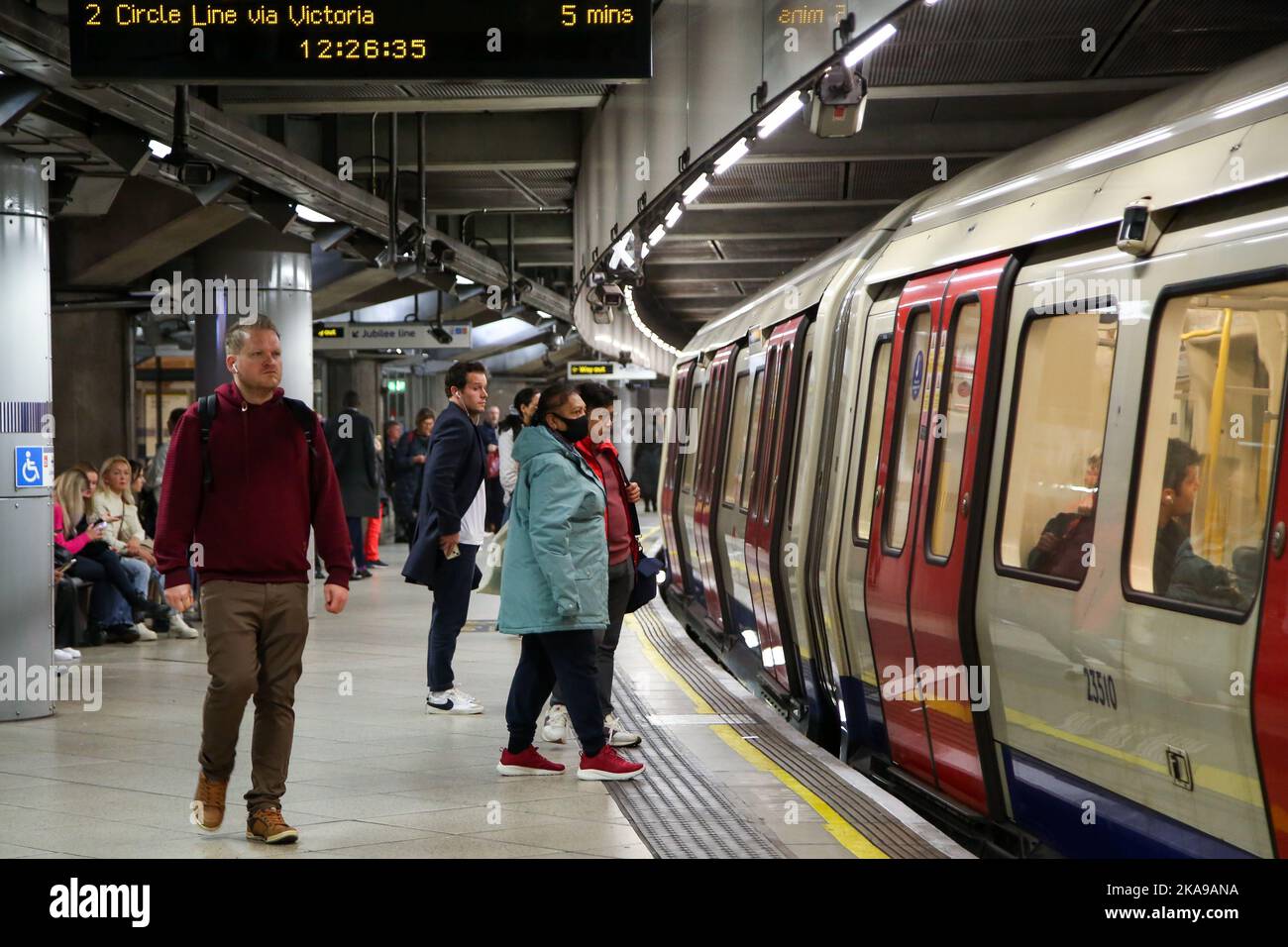 Passengers seen at Westminster underground station as a train arrives ...