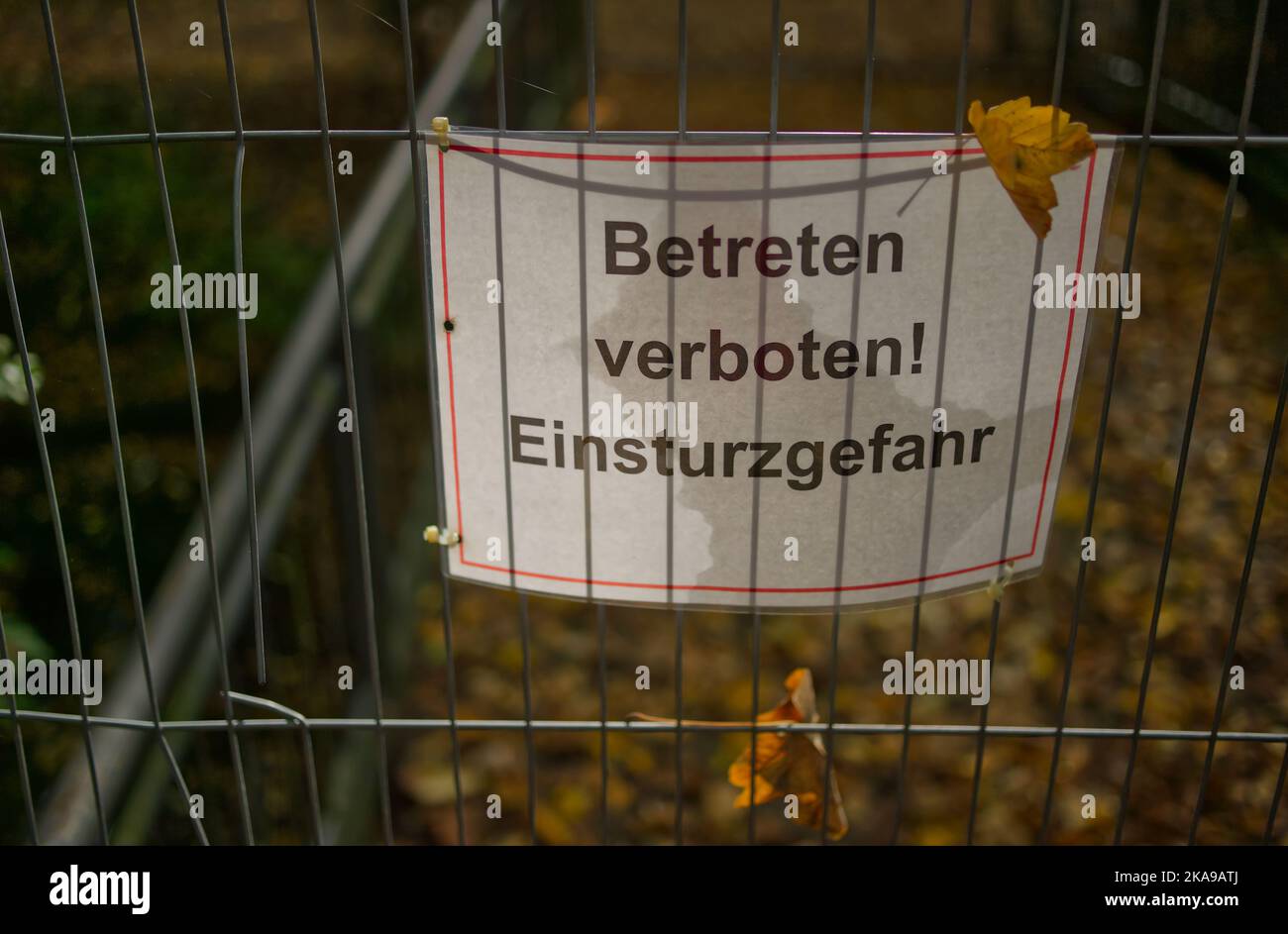 warning sign in German at a fence with inscription: Keep off because of ...
