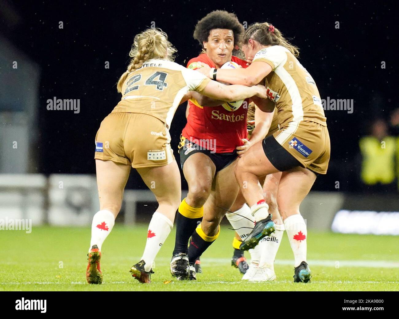 Papua New Guinea's Elsie Albert (centre) is tackled by Canada's ...