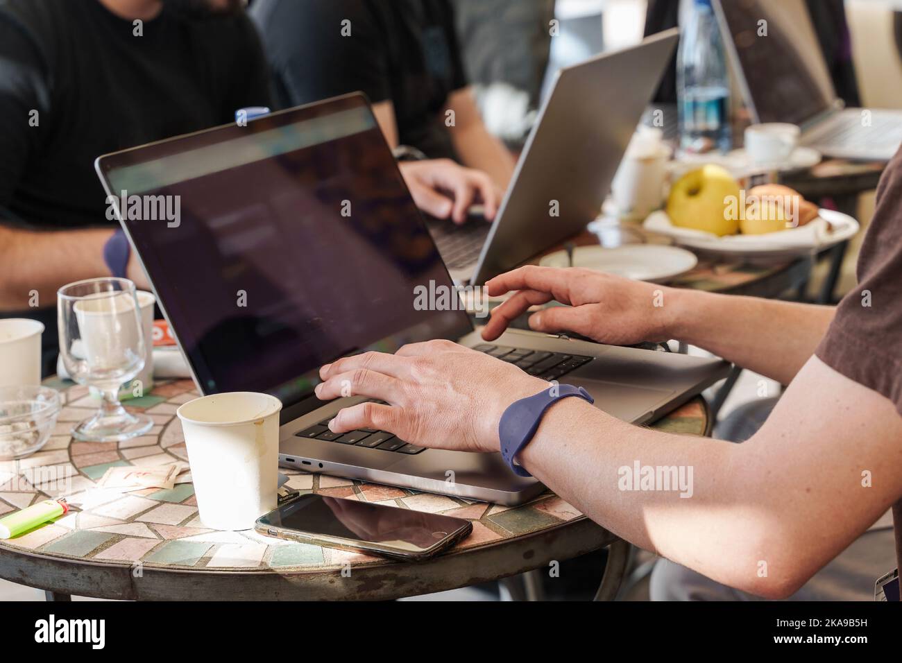 Smart men in casual style working on their laptop computers in team at ...
