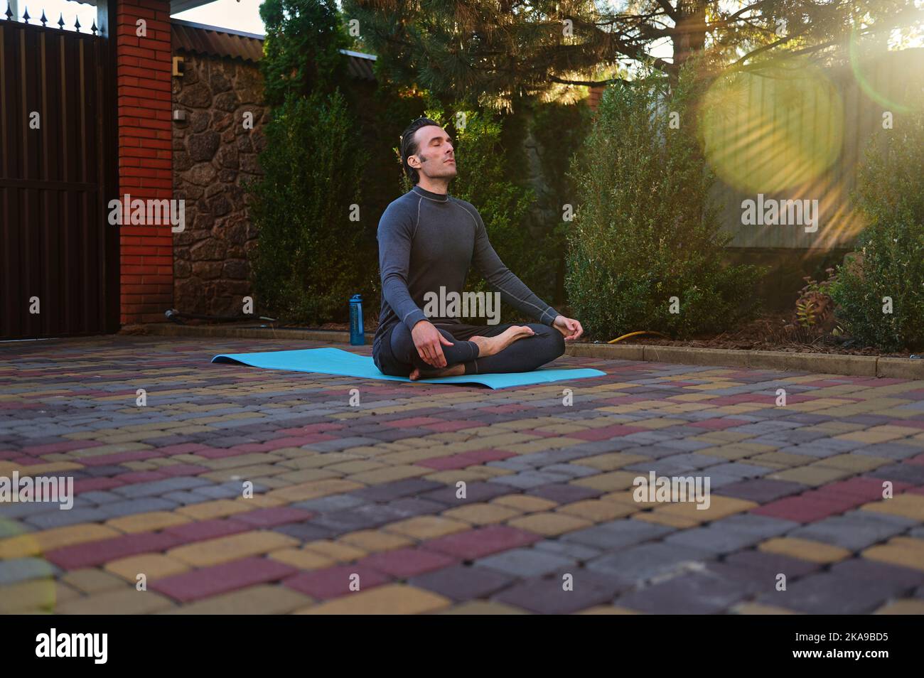 Peaceful man yogi, athlete meditating in lotus pose outdoors ...