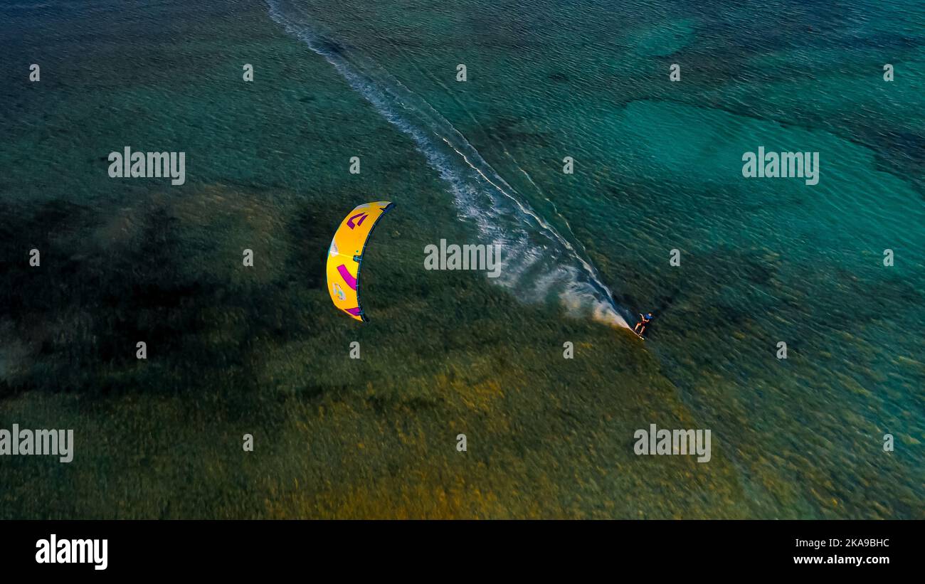 A brave kite surfer crossing the turquoise water of the ocean Stock ...