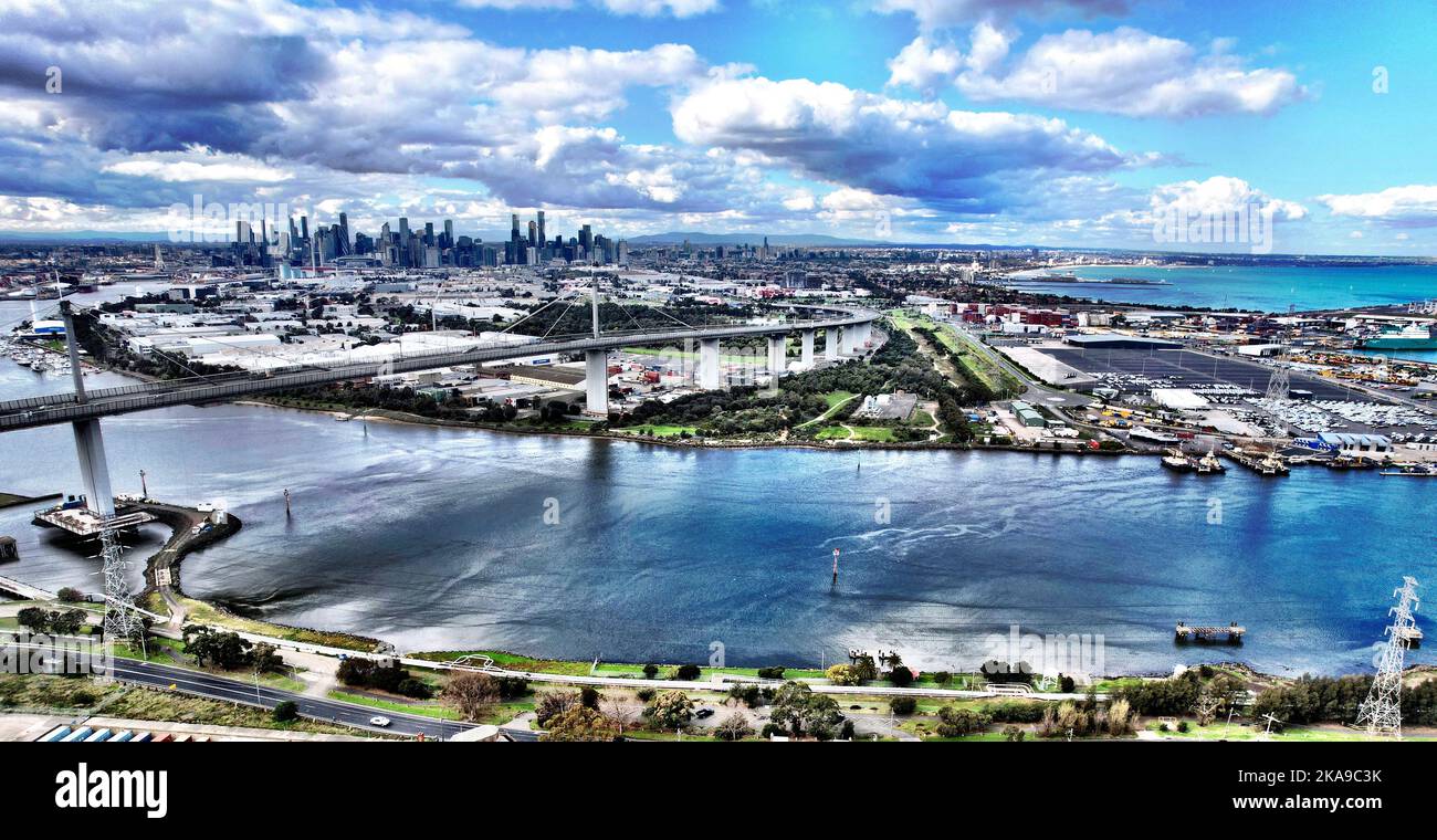 An aerial view of a bridge built over a long river in Melbourne ...