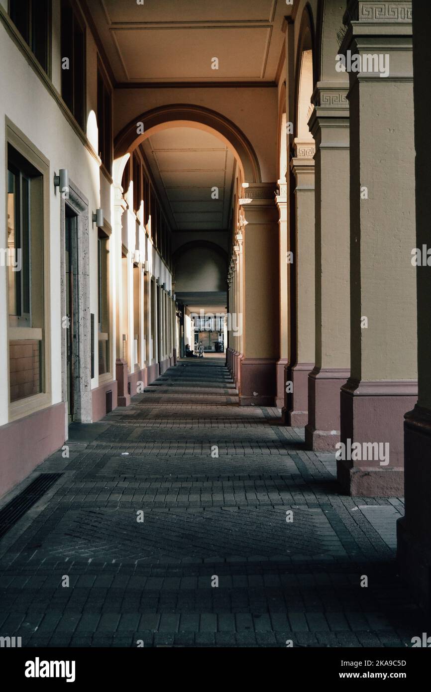 A vertical shot of an arcade of colonnade inside a medieval building ...