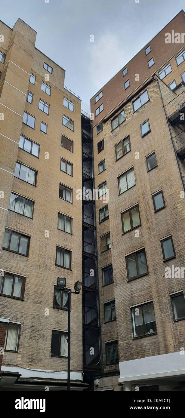 A low-angle shot of a building with inside stairs seen from transparent ...