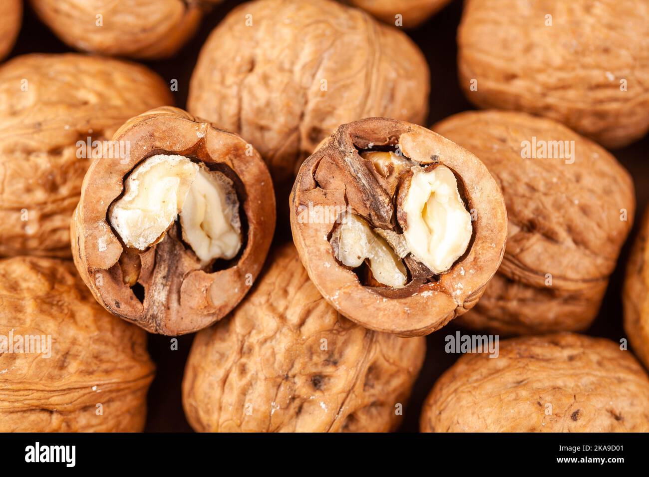 The walnuts on a brown wooden background Stock Photo - Alamy
