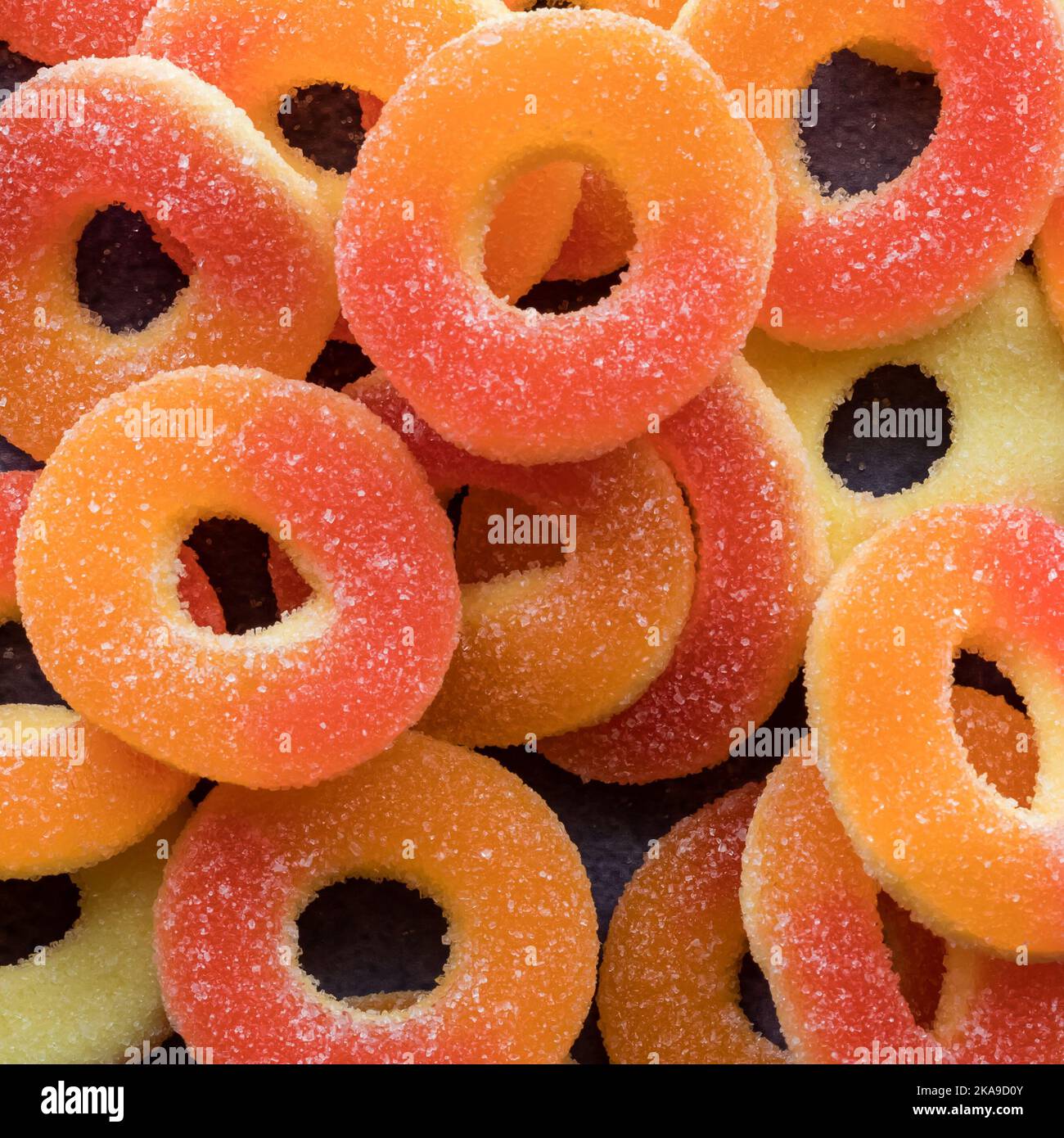 Top down view of bright colourful sugar coated peach flavoured gummy ...