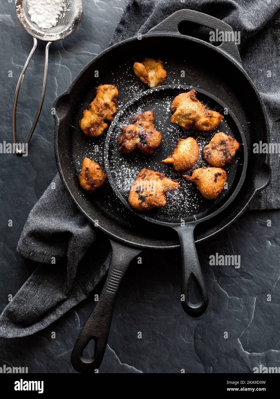 Cast iron fry pans filled with homemade deep fried sweet blueberry ...