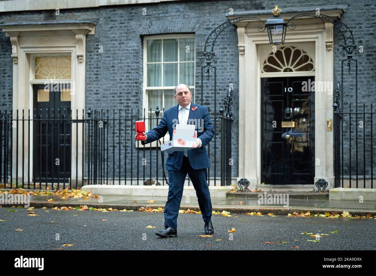 Defence Secretary Ben Wallace with a poppy collection box and poppies ...
