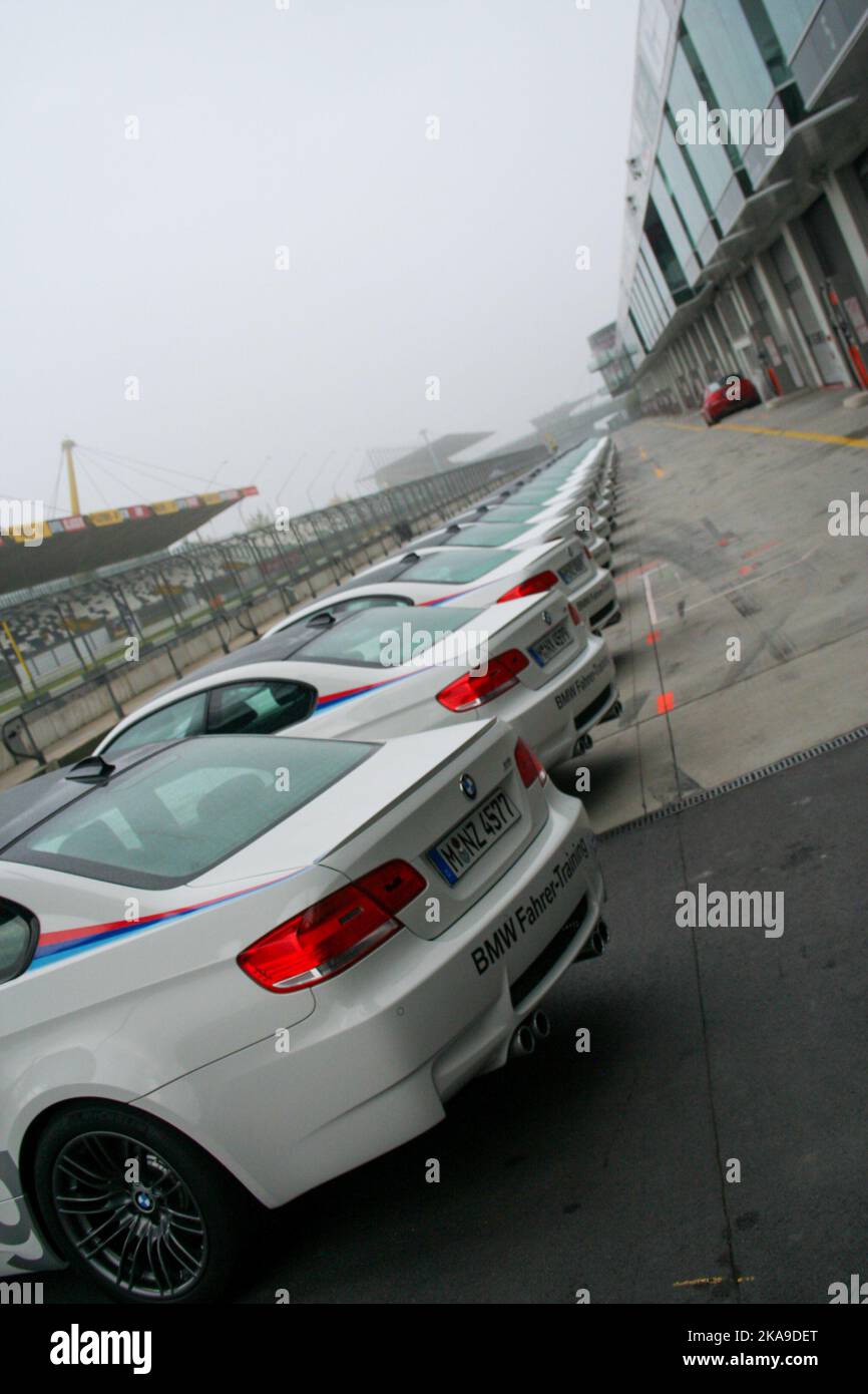A vertical shot of a row of 2008 BMW E90 M3 white cars at the ...