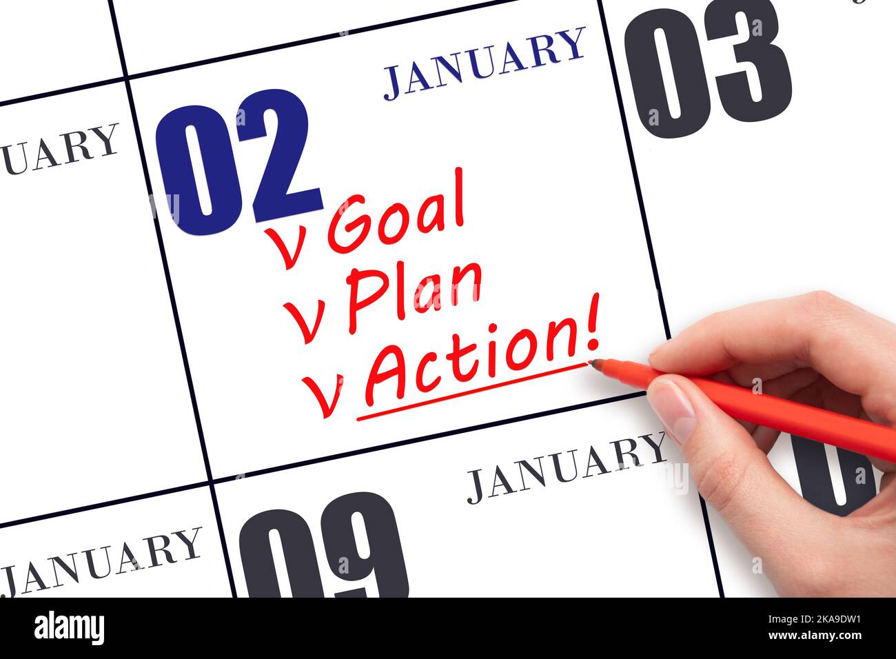 2nd day of January. Hand writing text GOAL PLAN ACTION on calendar date ...