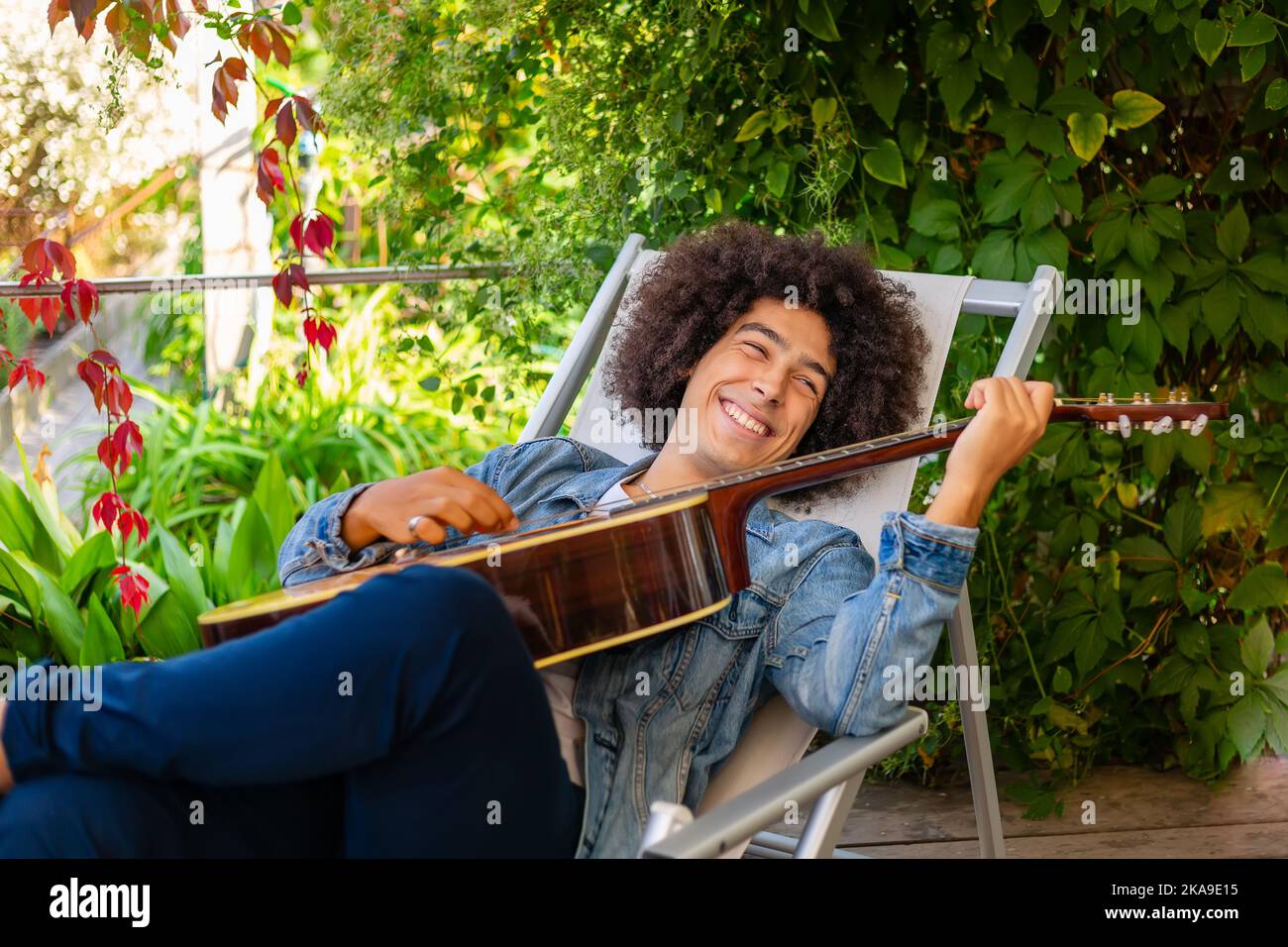 Beautiful young Afro-Italian mixed race man in casual wear playing ...