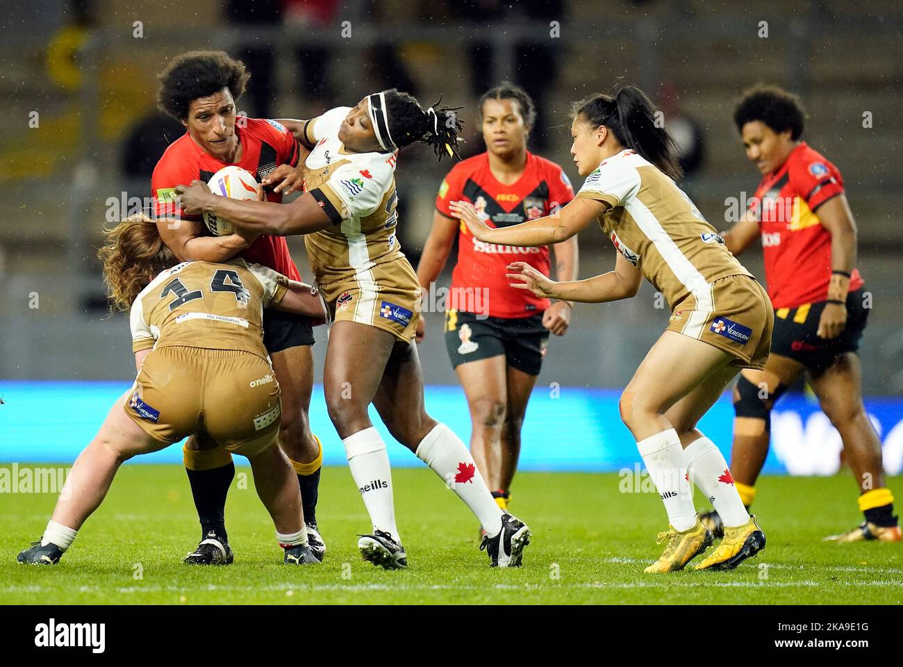 Papua New Guinea's Elsie Albert is tackled by Canada's Maddy Aberg ...