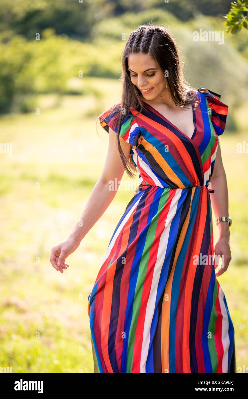 A beautiful caucasian female posing for a photo in a field on a sunny ...