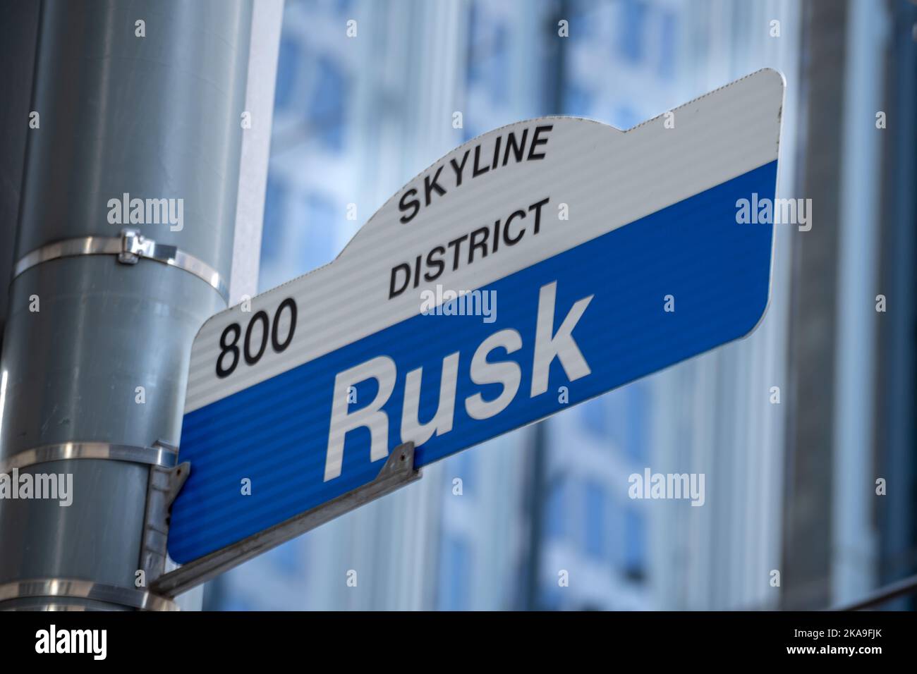 A "Rusk" street sign in Downtown Houston, Texas in a blurred background ...